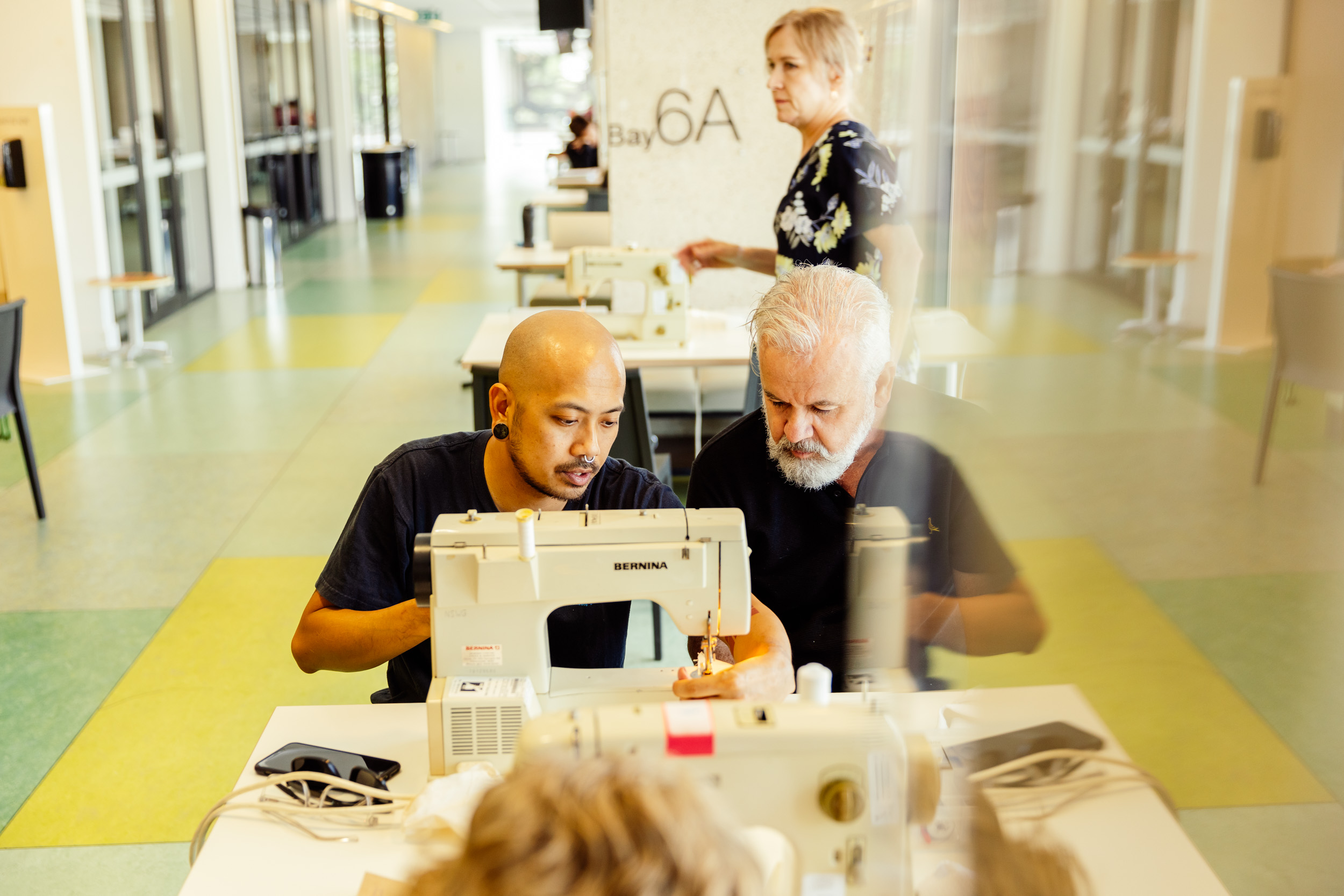 Two people sewing | State Library of Queensland