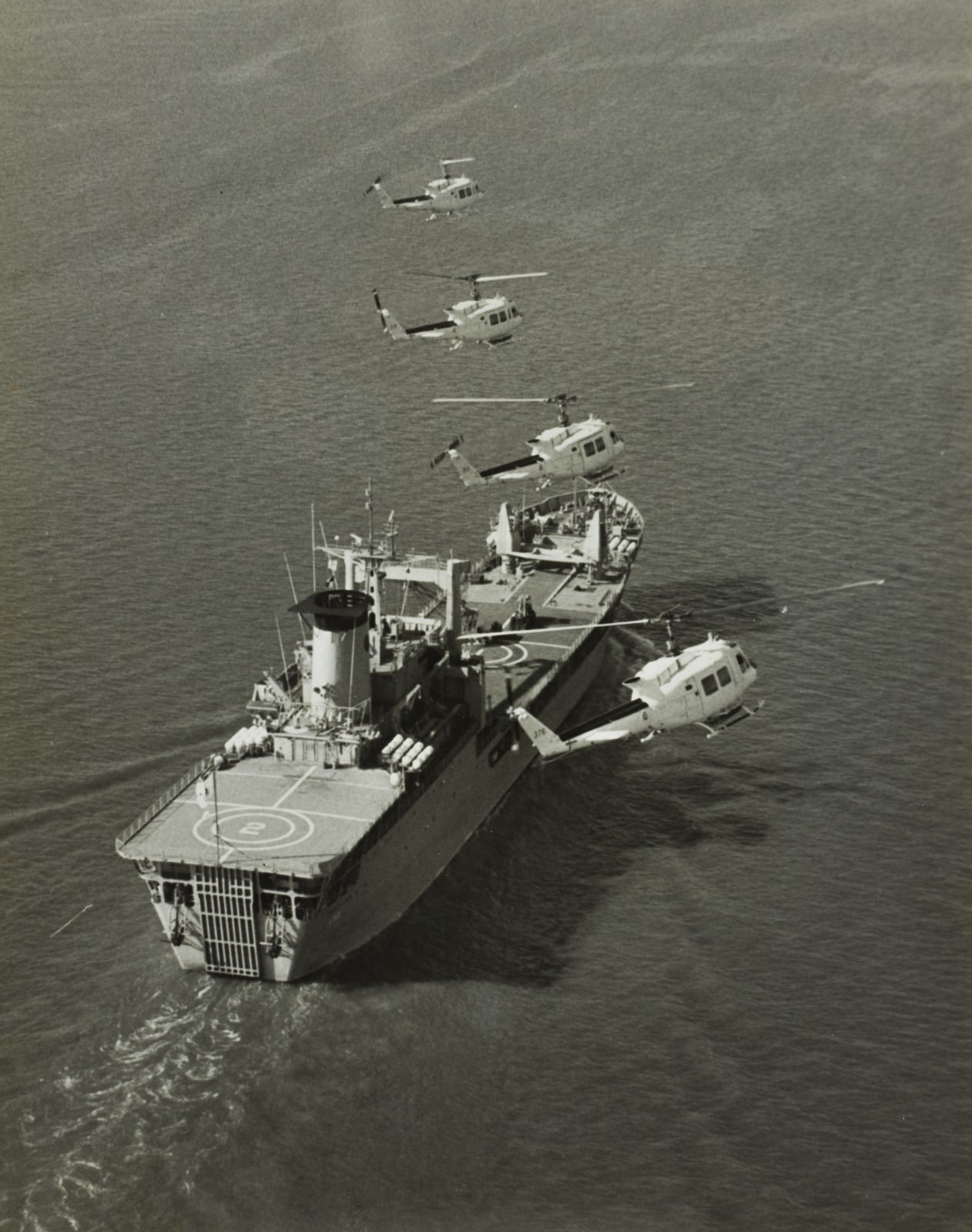 RAAF Iroquois helicopters preparing to land on HMAS Tobruk, Moreton Bay ...