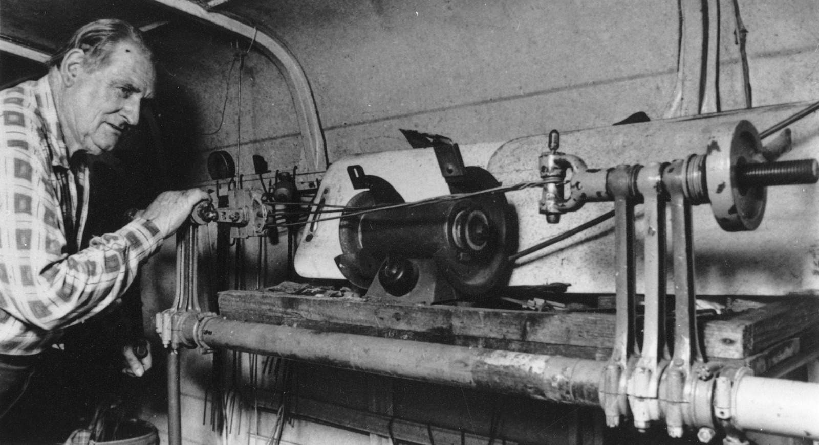 Factory worker operating machinery, Brisbane | State Library of Queensland